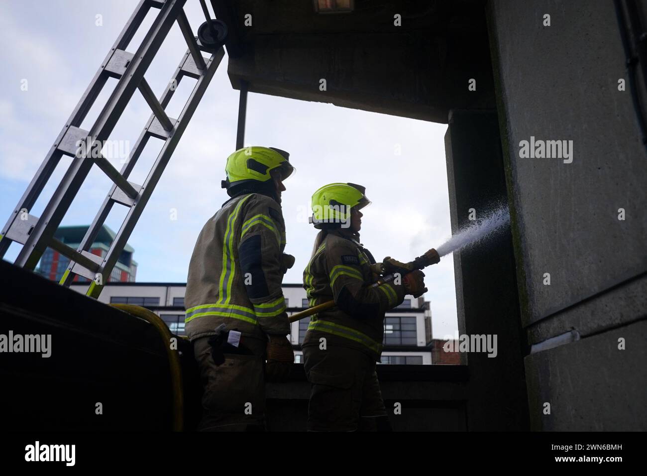 Firefighter officers run through a practice drill during a London Fire ...