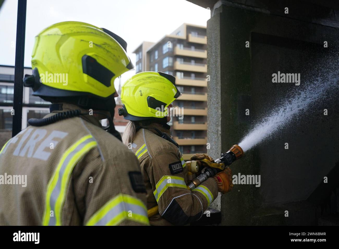 Firefighter officers run through a practice drill during a London Fire ...