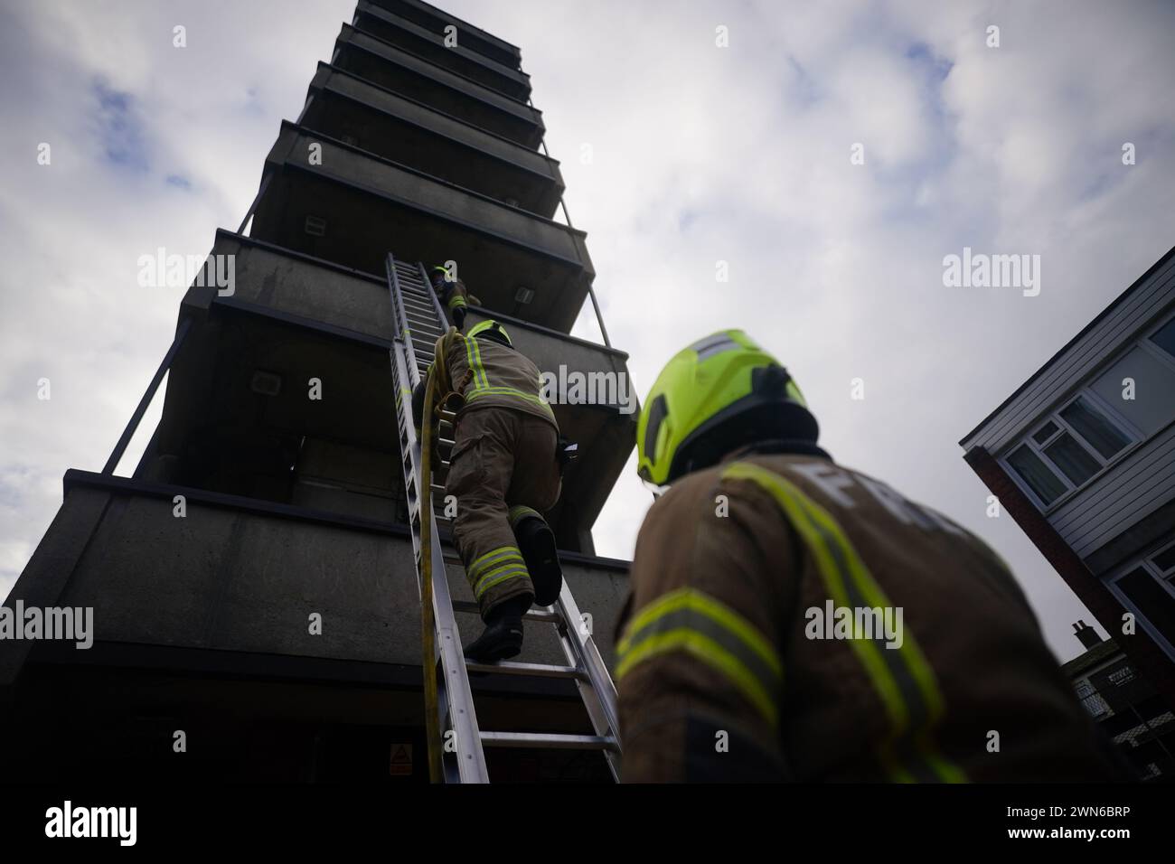 Firefighter officers run through a practice drill during a London Fire ...