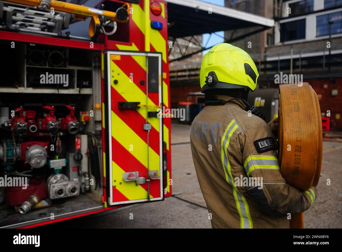Firefighter officers run through a practice drill during a London Fire ...