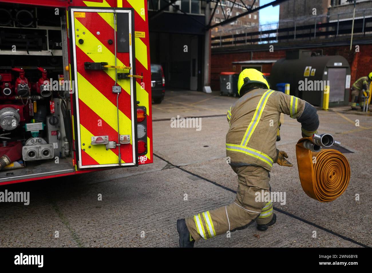 Firefighter officers run through a practice drill during a London Fire ...