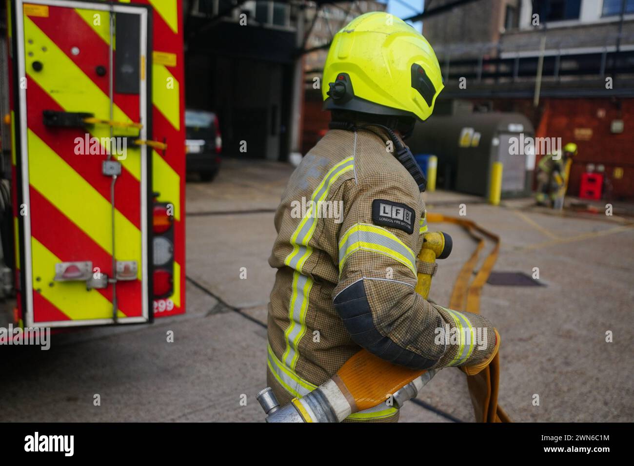 Firefighter officers run through a practice drill during a London Fire ...