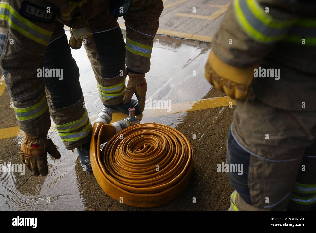 Firefighter officers run through a practice drill during a London Fire ...