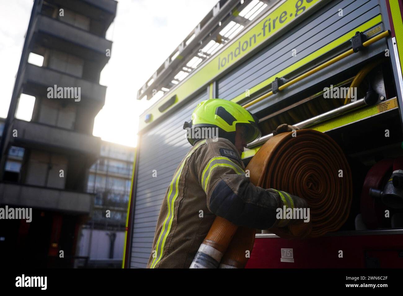 Firefighter officers run through a practice drill during a London Fire ...
