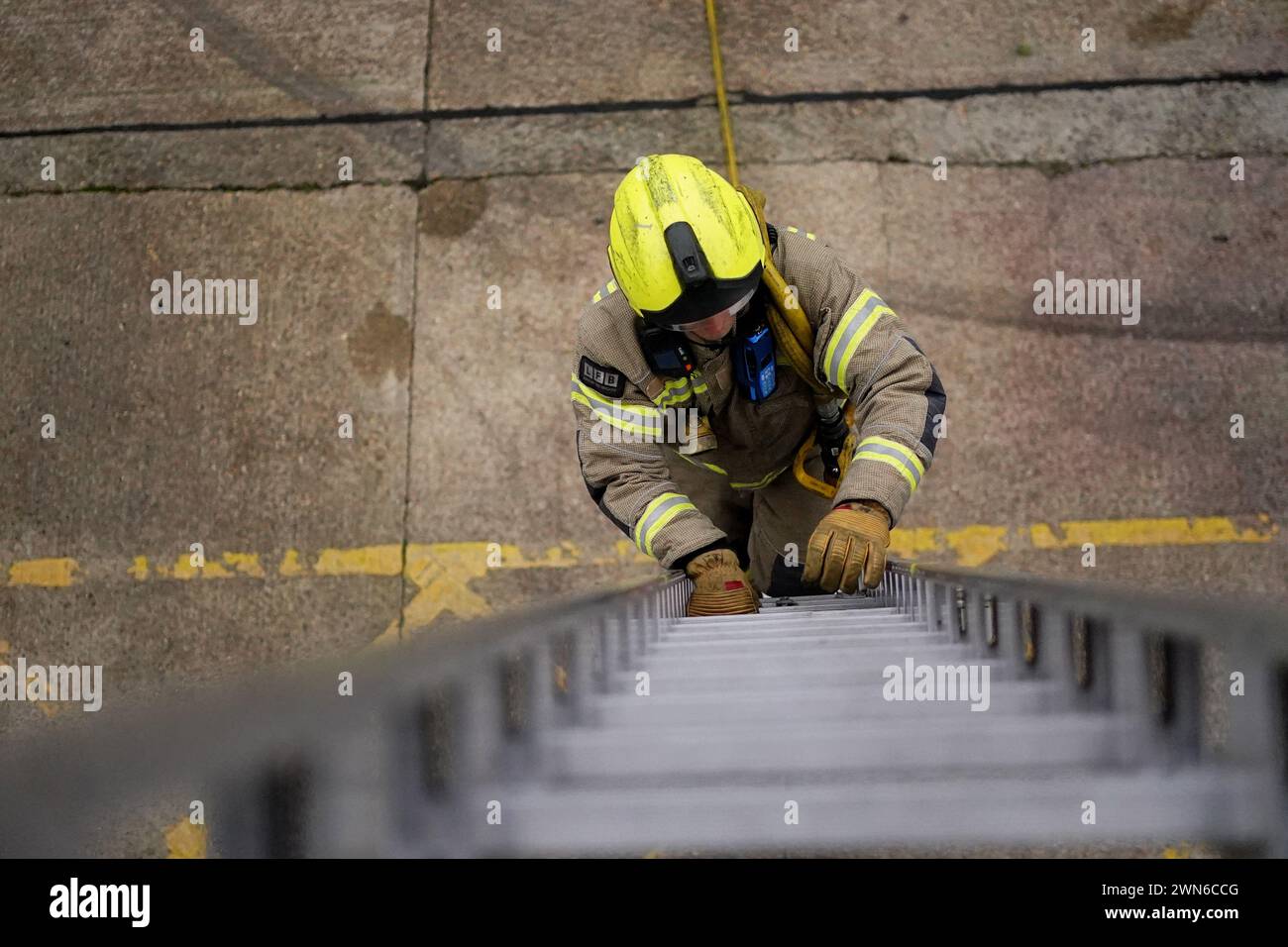 Firefighter officers run through a practice drill during a London Fire ...