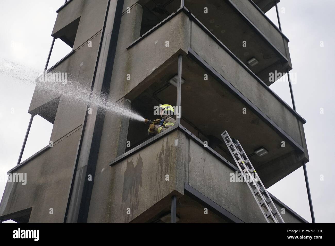Firefighter officers run through a practice drill during a London Fire ...