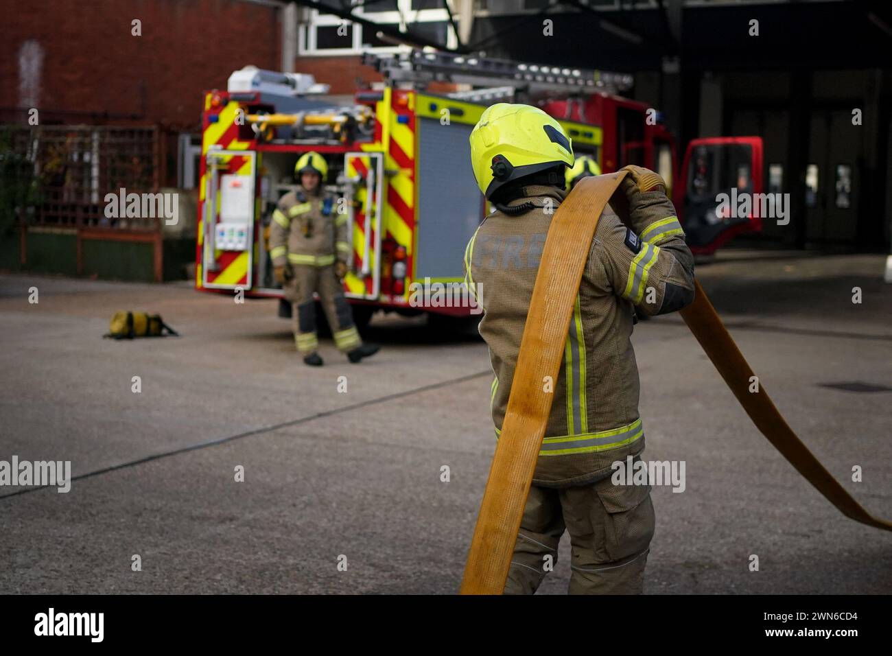 Firefighter officers run through a practice drill during a London Fire ...