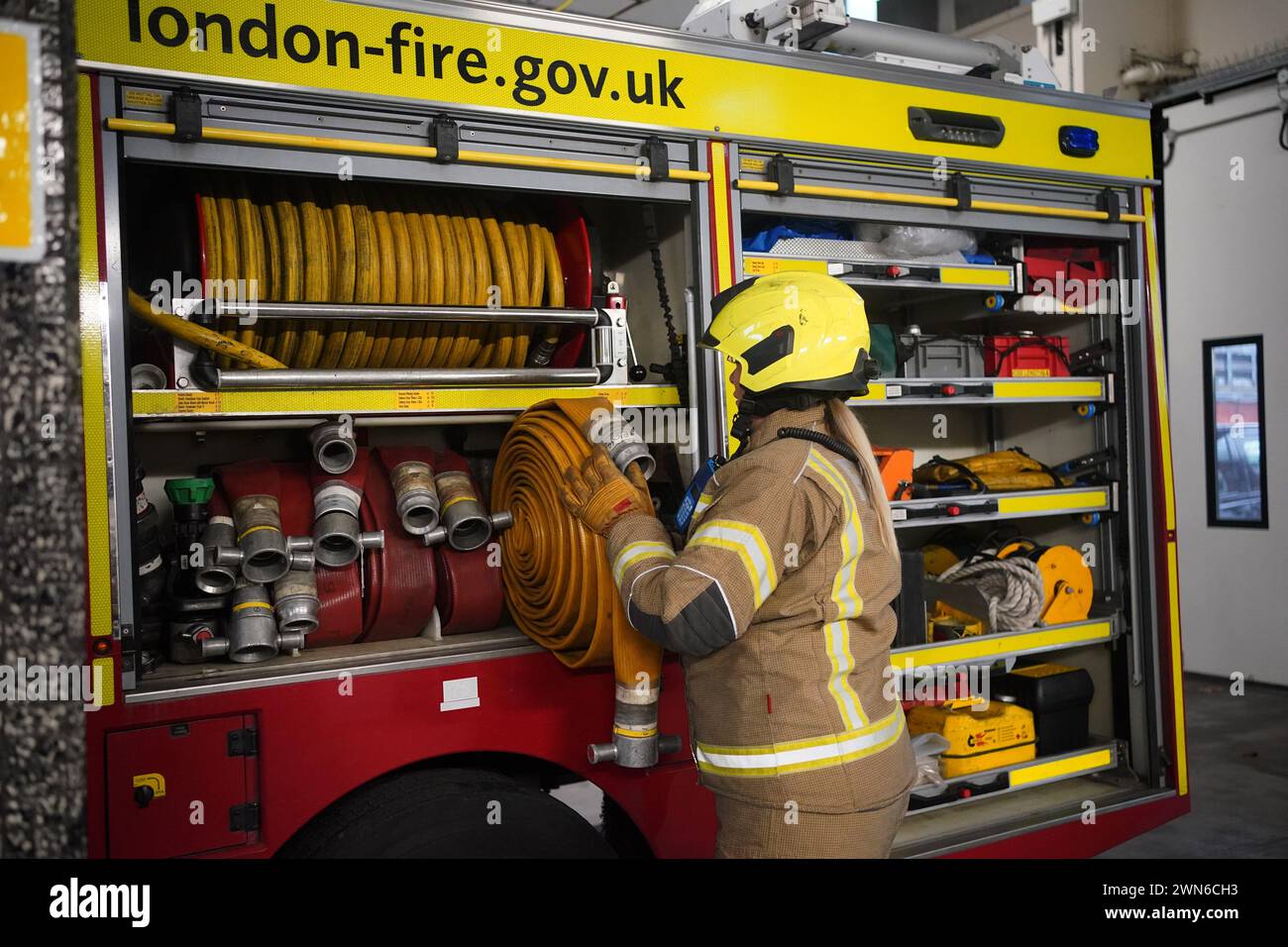 Firefighter officers run through a practice drill during a London Fire ...