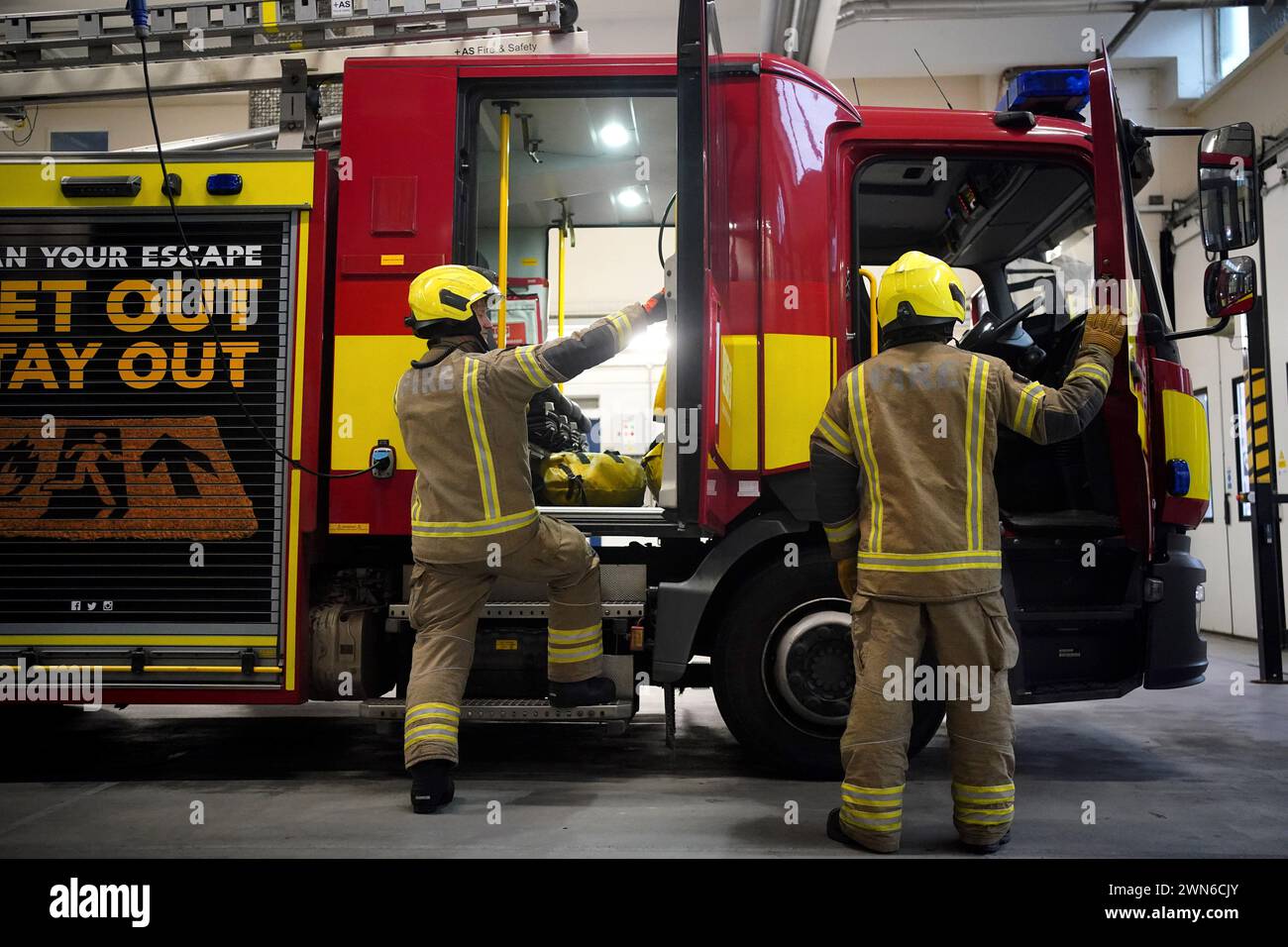 Firefighter officers run through a practice drill during a London Fire ...