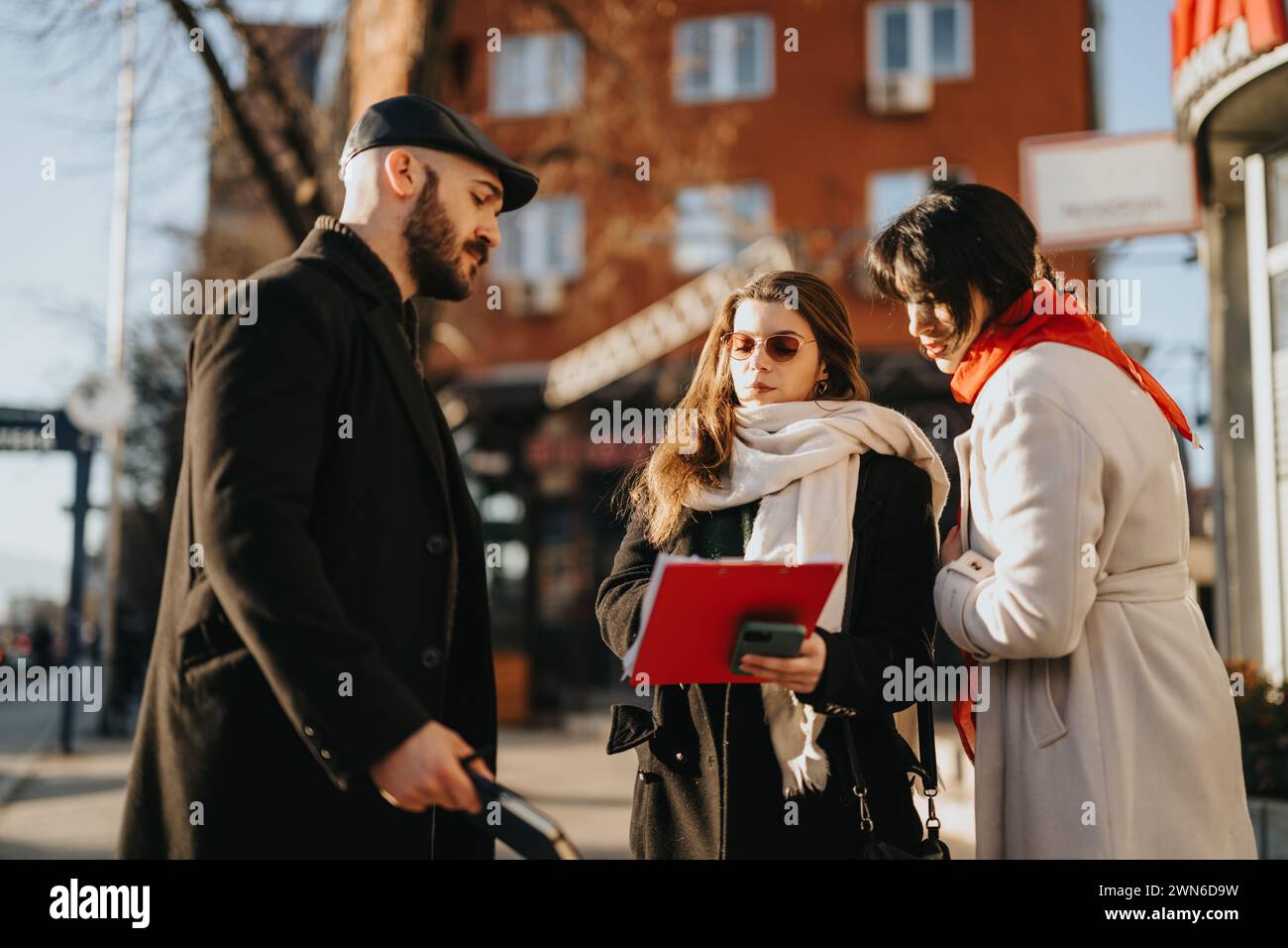 Multicultural business team brainstorming strategy in urban outdoor ...