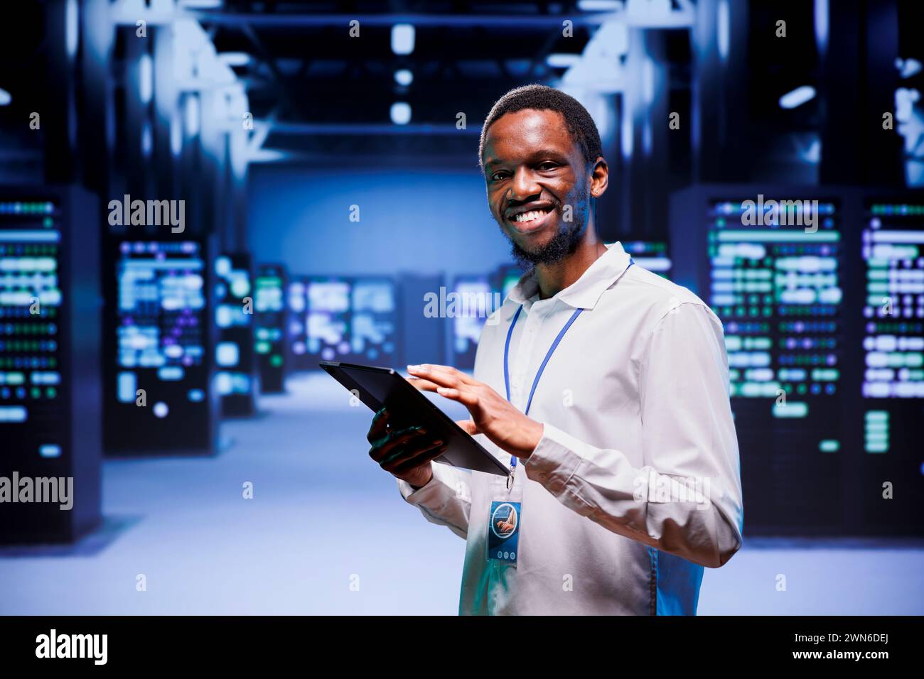 Portrait of african american administrator in front of server clusters ...