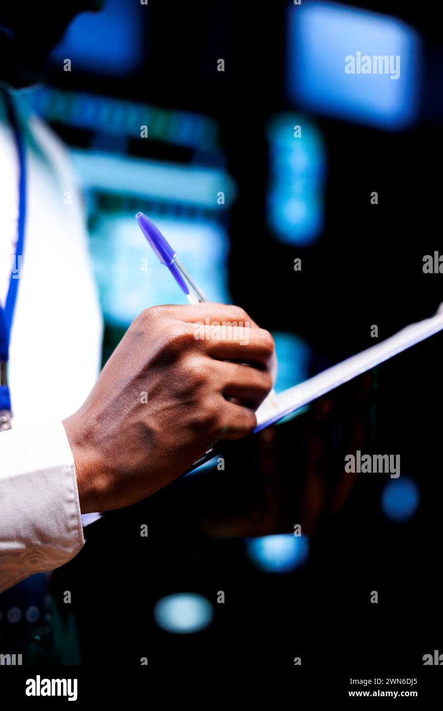 Close up shot of diligent engineer equipped with maintenance checklist ...