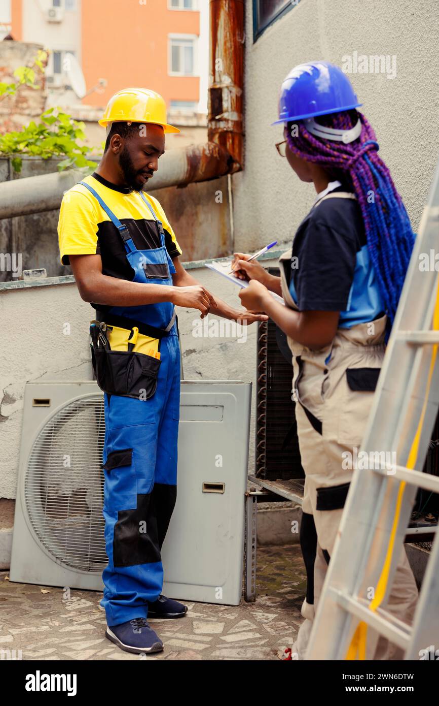 Efficient technicians repairing and maintaining condenser heating and ... Efficient technicians repairing and maintaining condenser heating and ...
