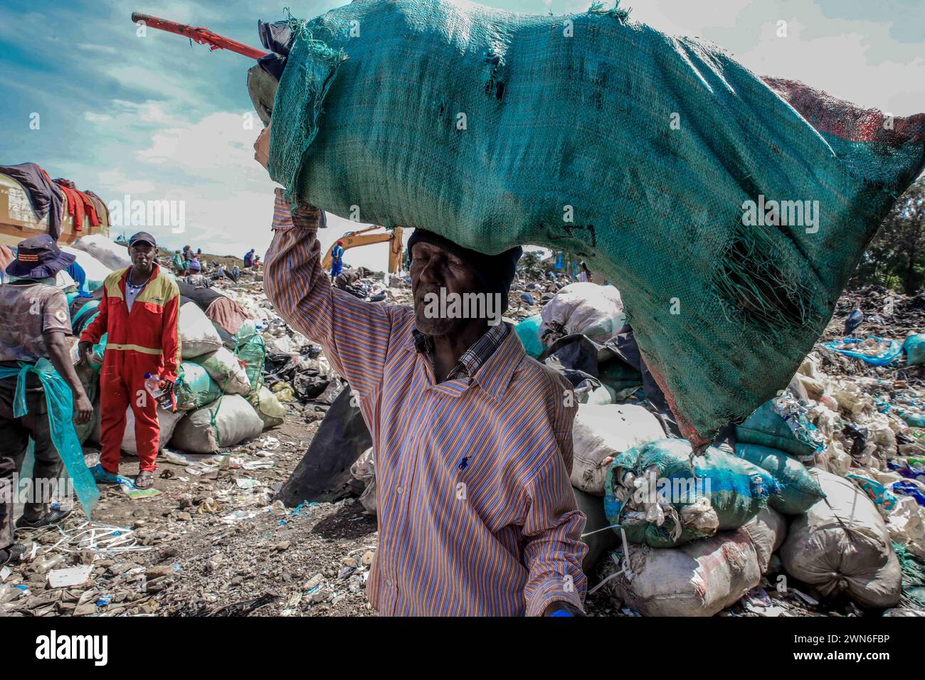 Nairobi, KENYA. 28th Feb, 2024. A waster collector carrying a sack of ...