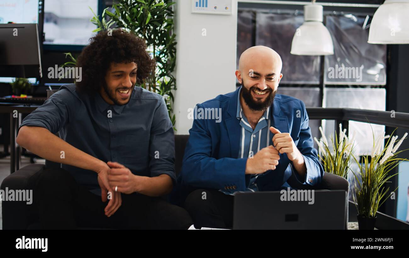 Research team celebrate business success in coworking space, doing ...