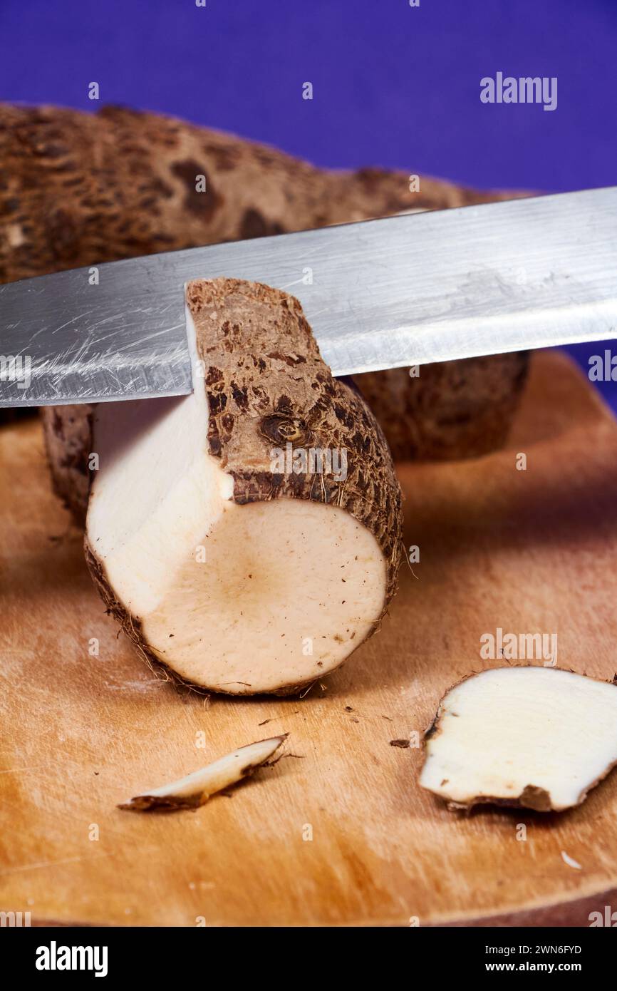 closeup of taro root vegetable, eddo malanga, purple background Stock ...