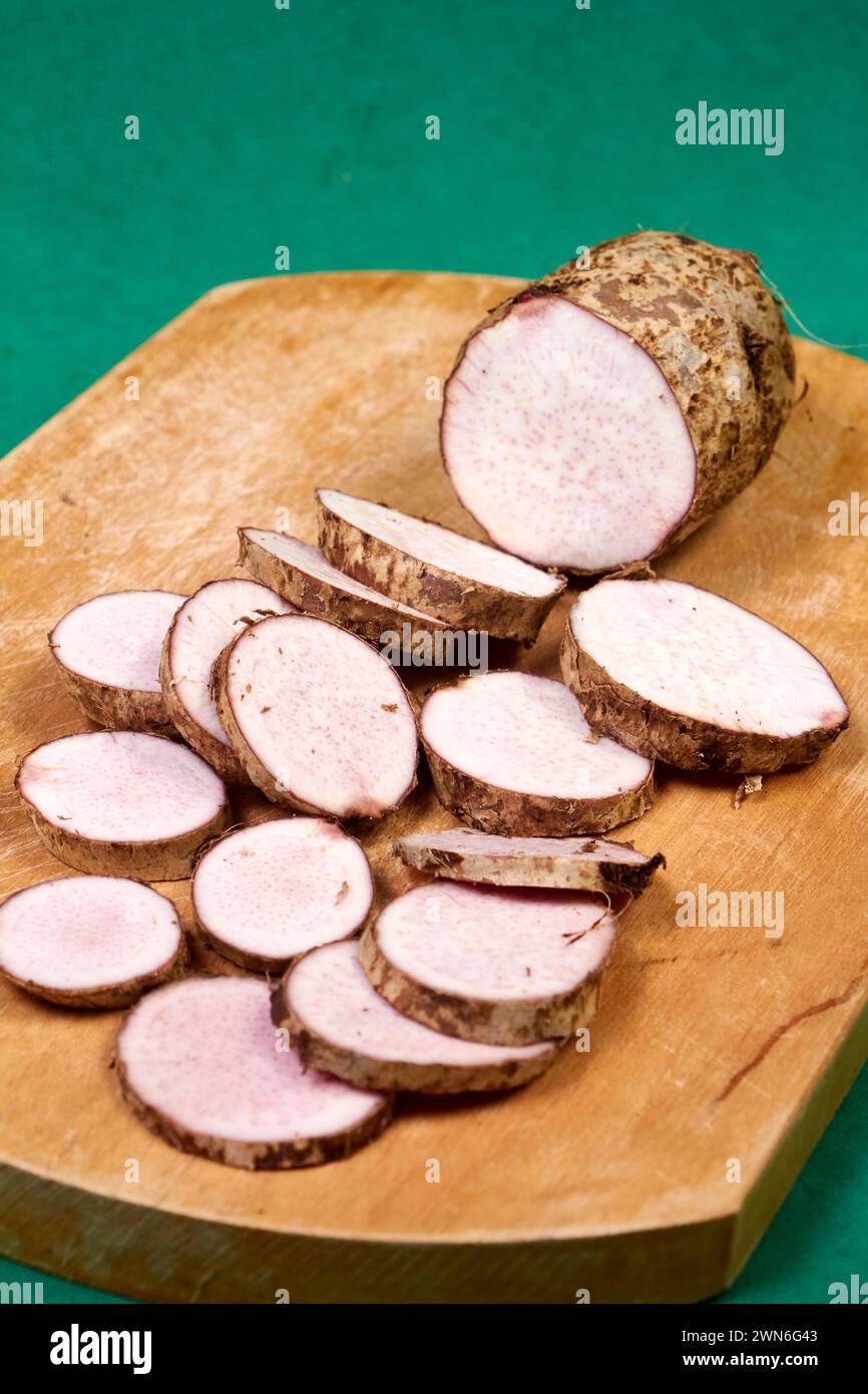 closeup of taro root vegetable, eddo malanga, green background Stock ...