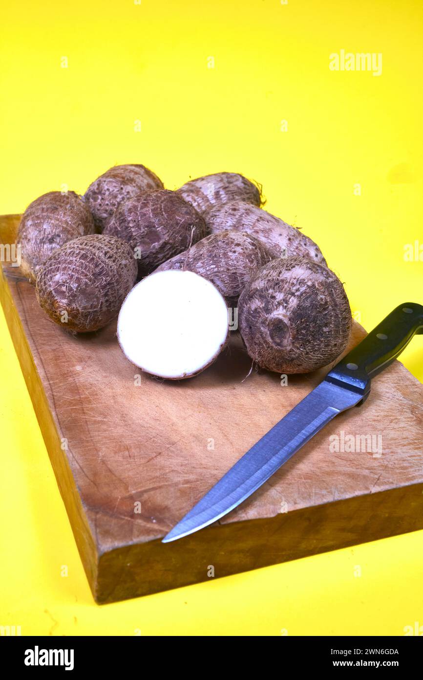 closeup of taro root vegetable, eddo malanga, yellow background Stock ...