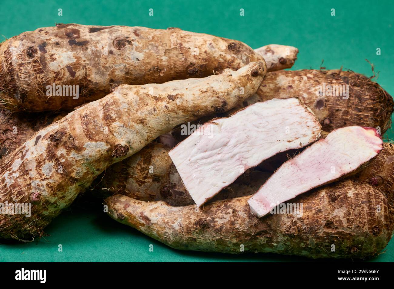 closeup of taro root vegetable, eddo malanga, green background Stock ...