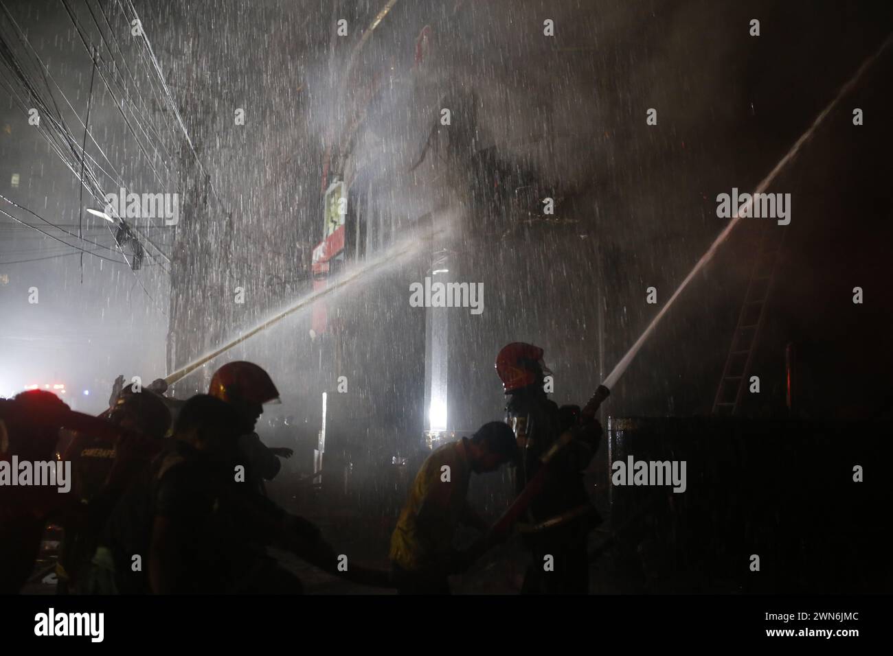 Firefighters are working to extinguish a fire in a commercial building ...