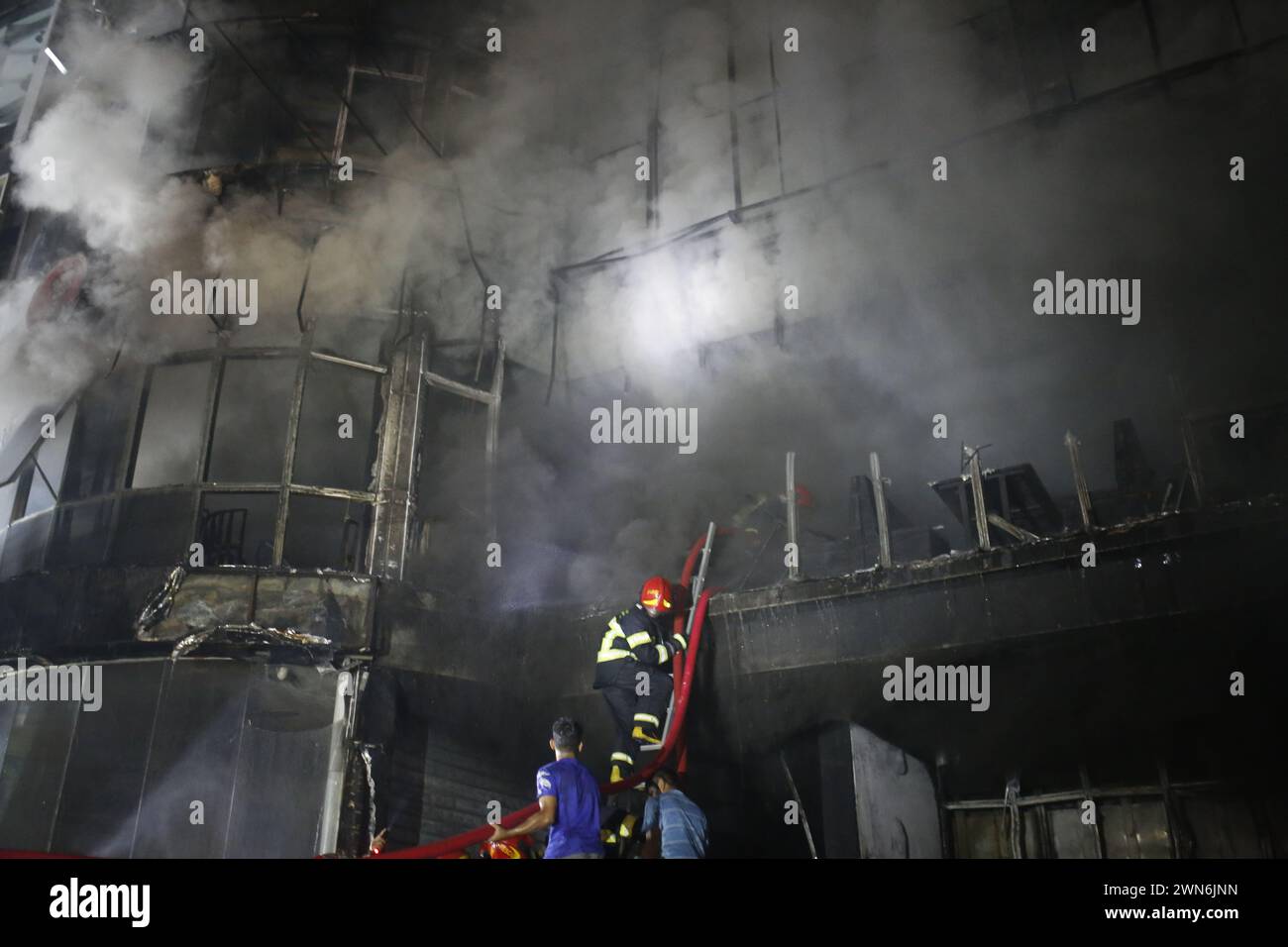 Firefighters are working to extinguish a fire in a commercial building ...