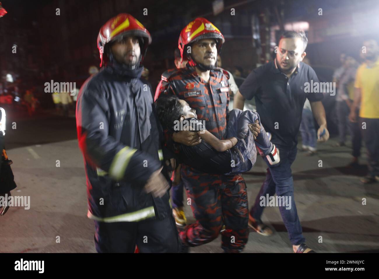 A firefighter is carrying an injured person during rescue operations ...