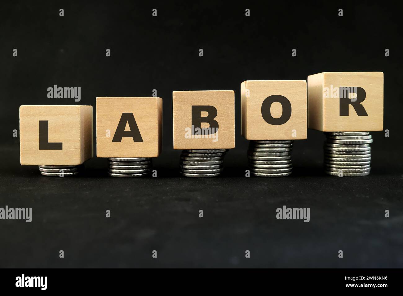 Increase in labor cost concept. Wooden blocks with increasing stack of ...