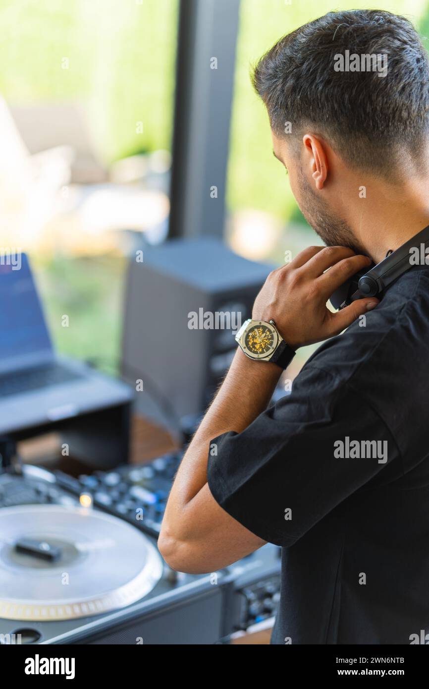 DJ with black t-shirt and watch mixing at a private party Stock Photo ...