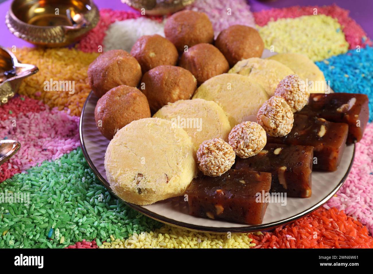 Diwali celebration. Tasty Indian sweets, colorful rangoli and diya ...