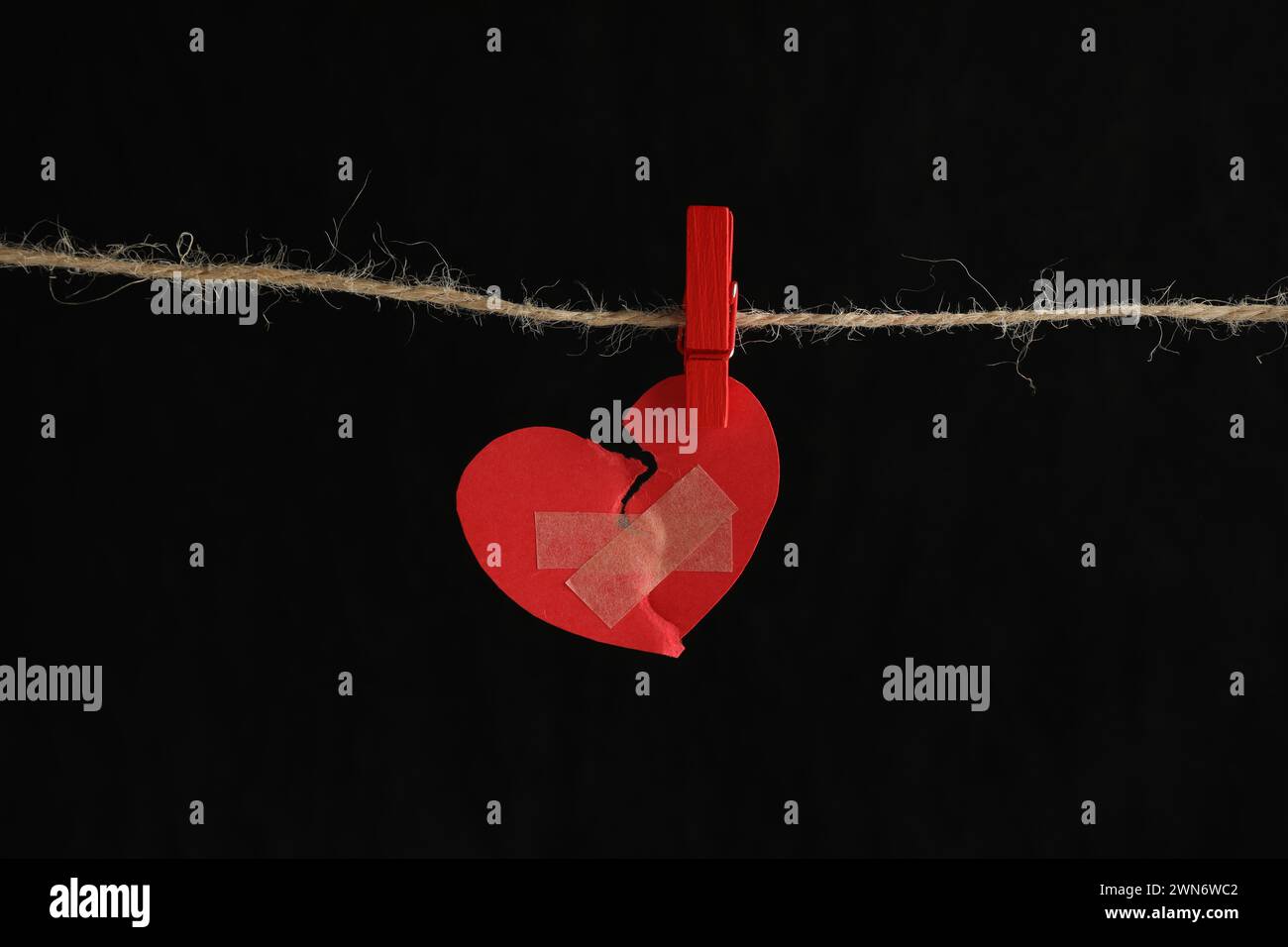 Broken heart. Torn red paper heart with medical adhesive bandages on ...