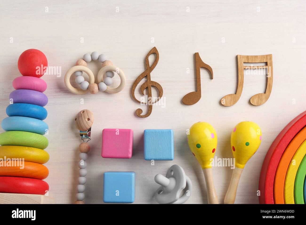 Baby song concept. Wooden notes, kids maracas and toys on table, flat ...