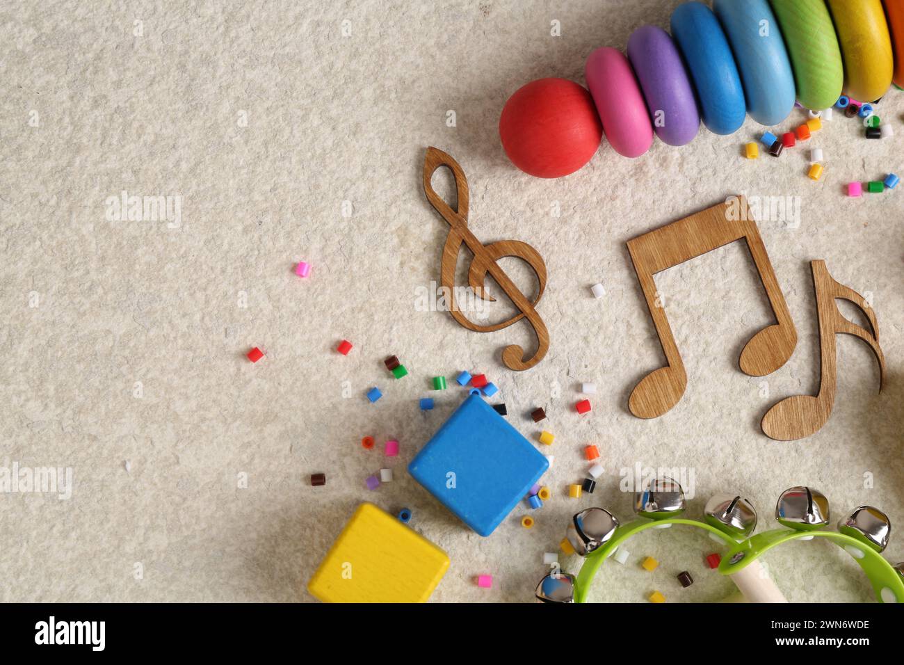 Baby song concept. Wooden notes, kids musical instruments and toys on ...