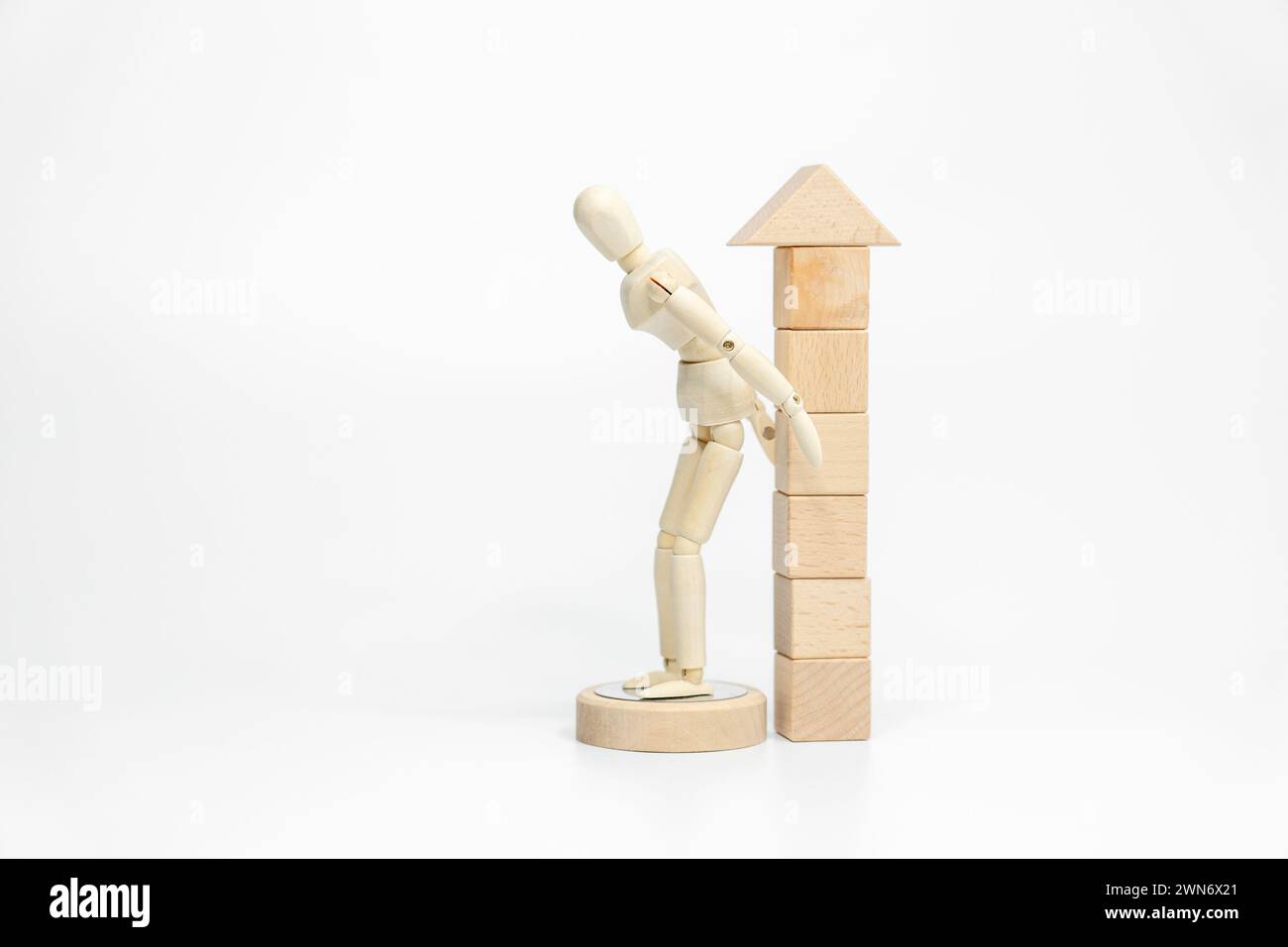 Wooden doll with wooden toy block isolated on white background ...