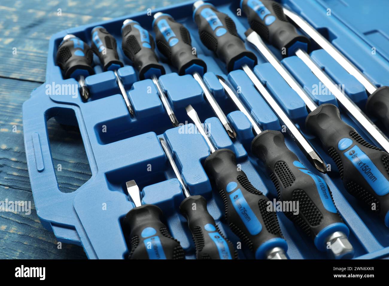 Set of screwdrivers in open toolbox on blue wooden table, closeup Stock ...