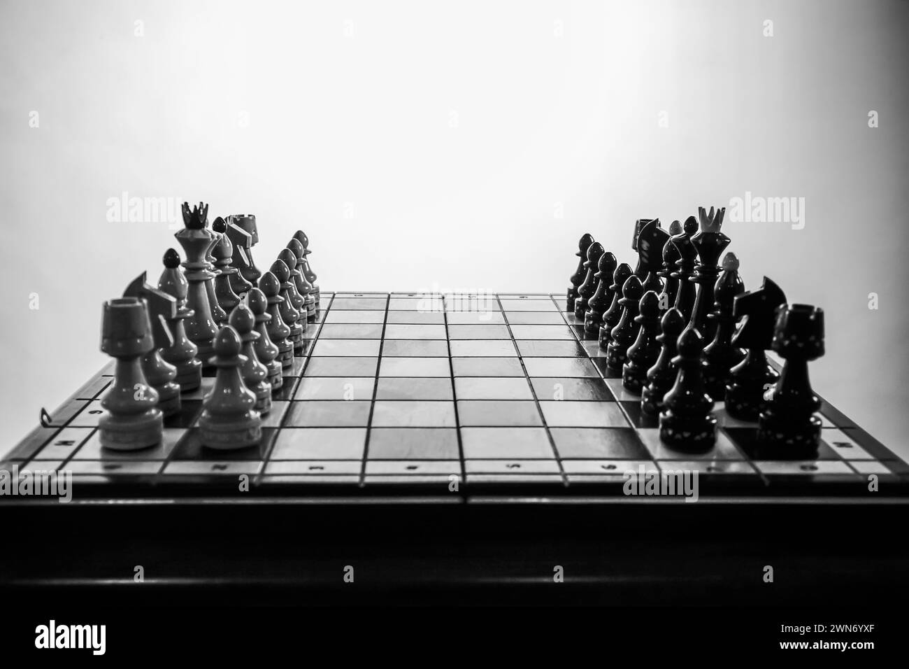 Chess board on the round white table. View with chess pieces on a chess ...