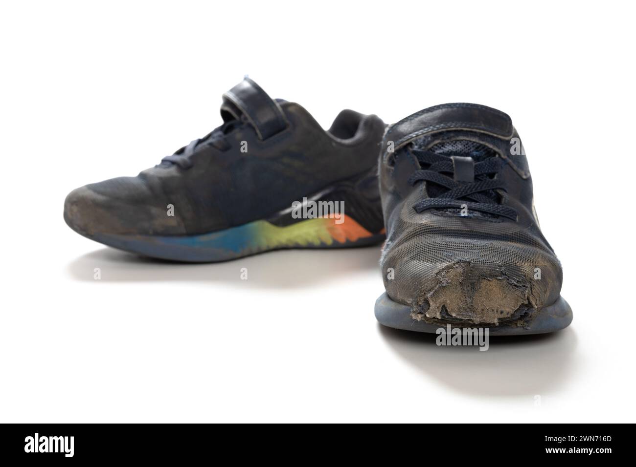pair of broken sporty shoes for kid on white background Stock Photo - Alamy