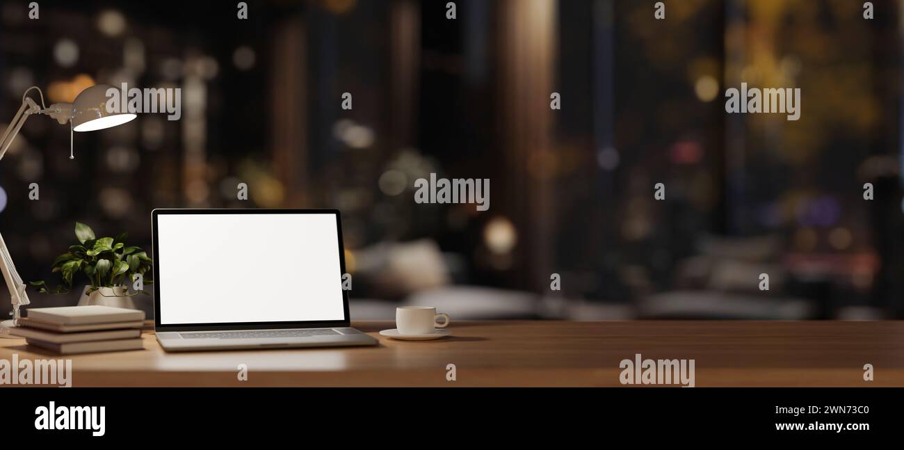 An office desk workspace in a modern dark office room at night features ...