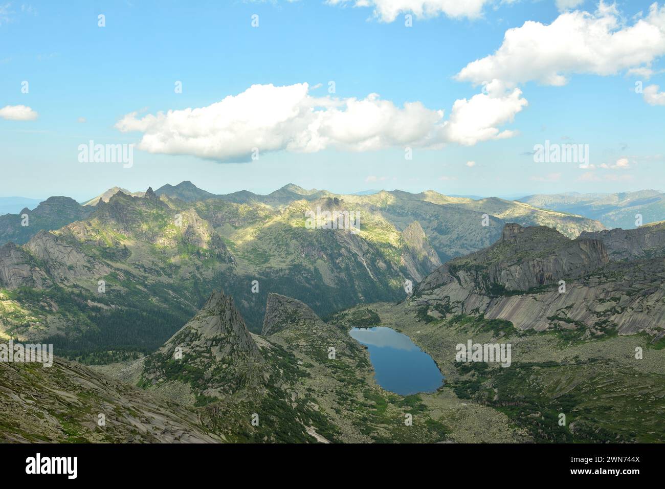 Top view of a rock of an unusual bizarre shape and a picturesque lake ...