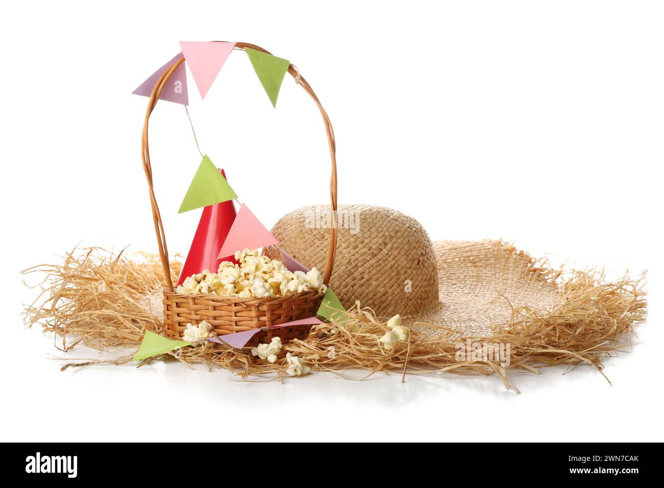 Basket of popcorn, paper flags and straw hat on white background. Festa ...