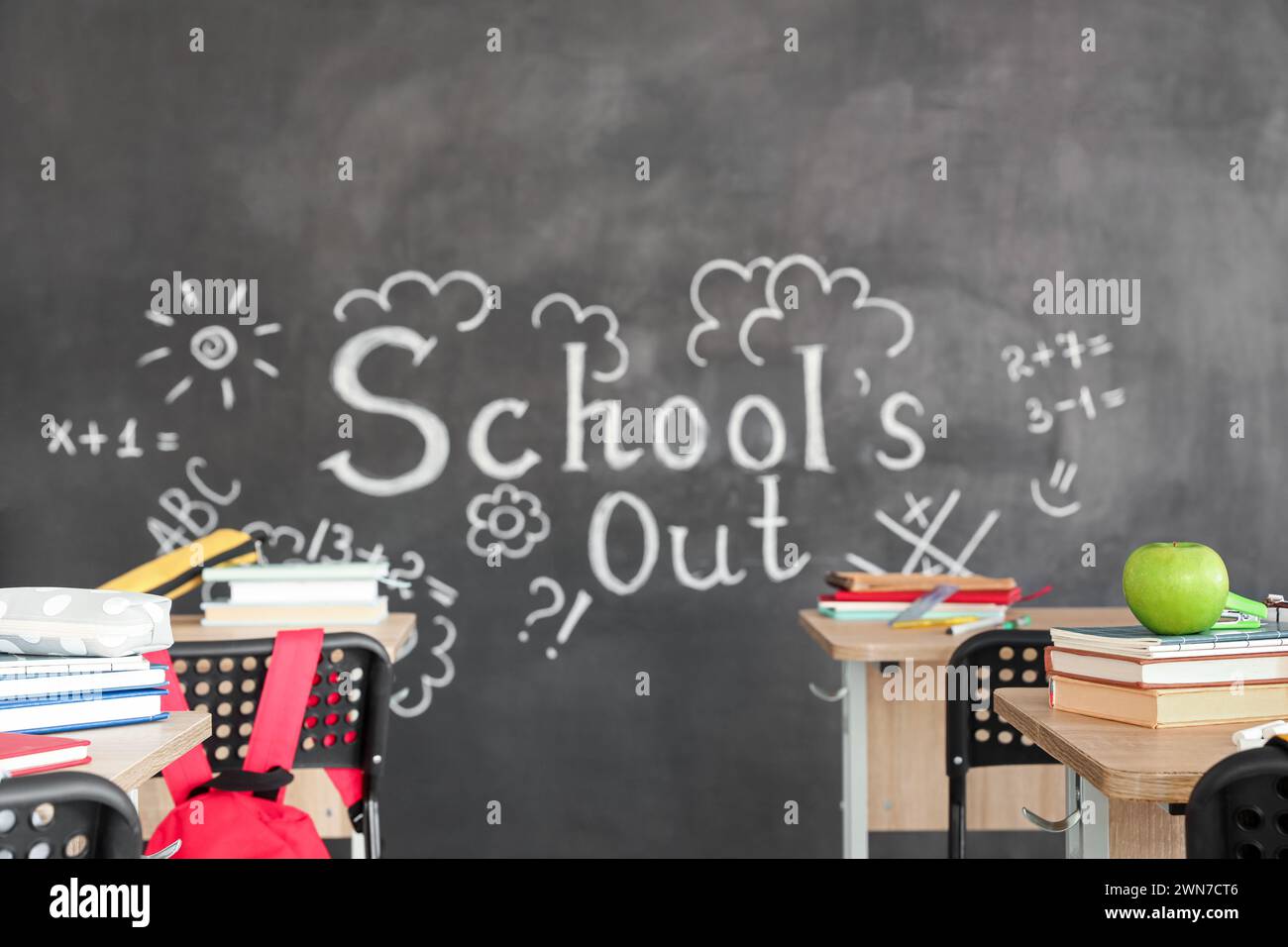 Text SCHOOL'S OUT with drawings on blackboard in classroom Stock Photo ...