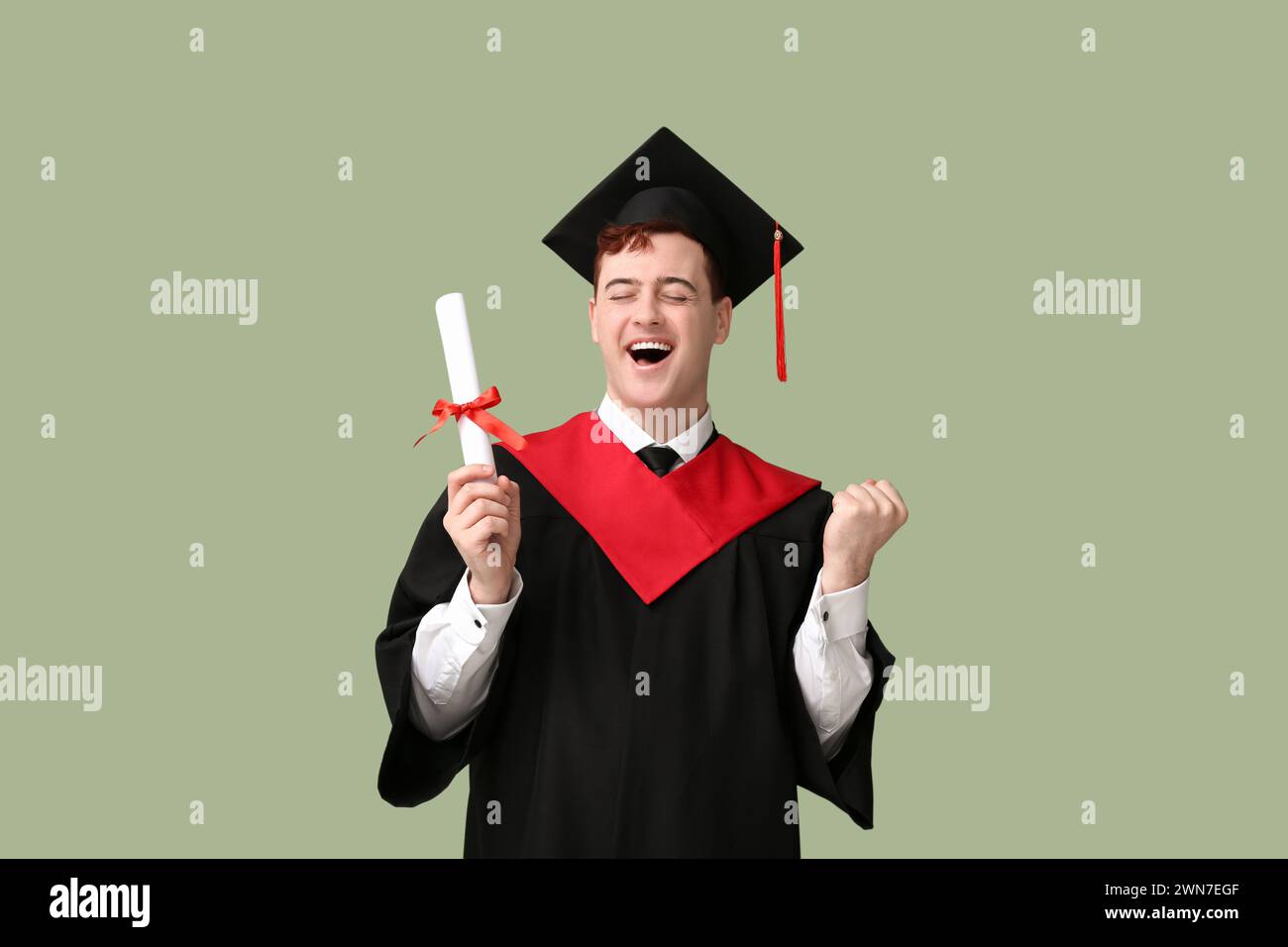 Happy graduating student with diploma on green background Stock Photo ...