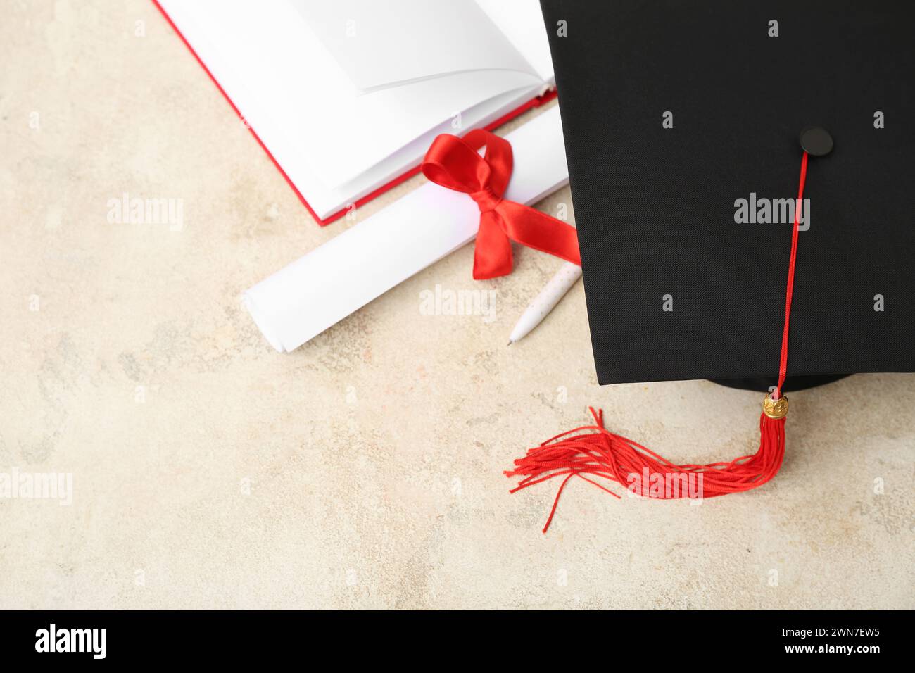 Mortar board with diploma and notebook on beige background Stock Photo ...