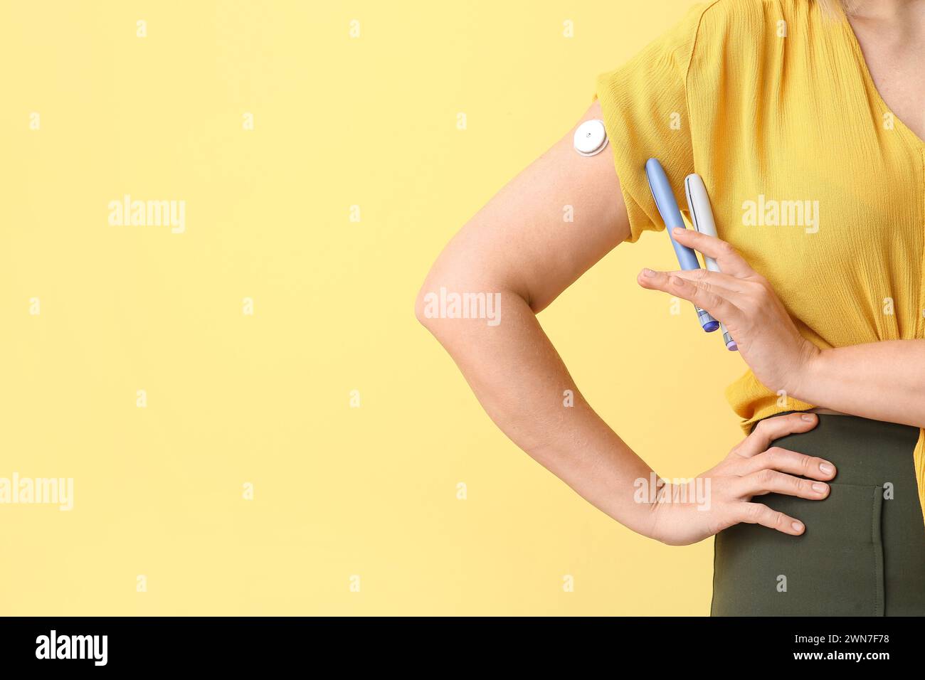 Woman With Glucose Sensor And Lancet Pens On Yellow Background
