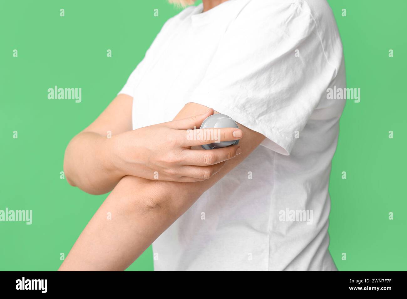 Woman with glucose sensor for measuring blood sugar level and ...