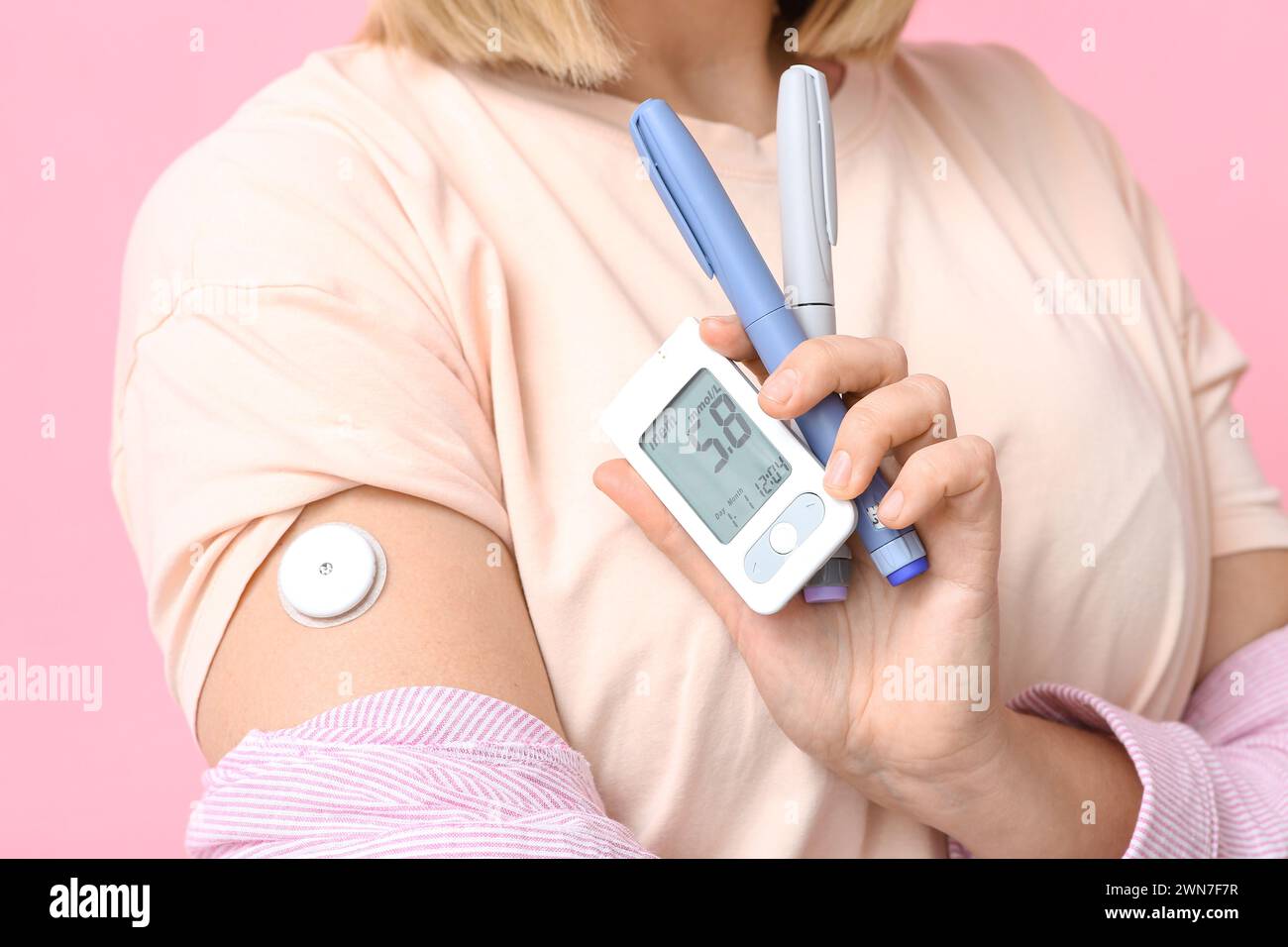 Woman with glucometer, sensor for measuring blood sugar level and ...
