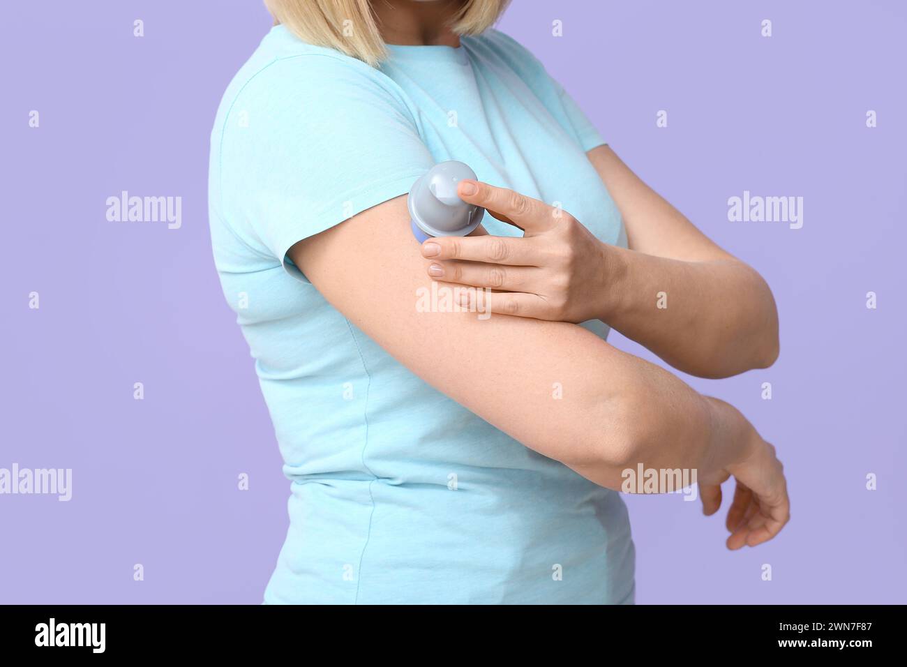 Woman with glucose sensor for measuring blood sugar level and ...