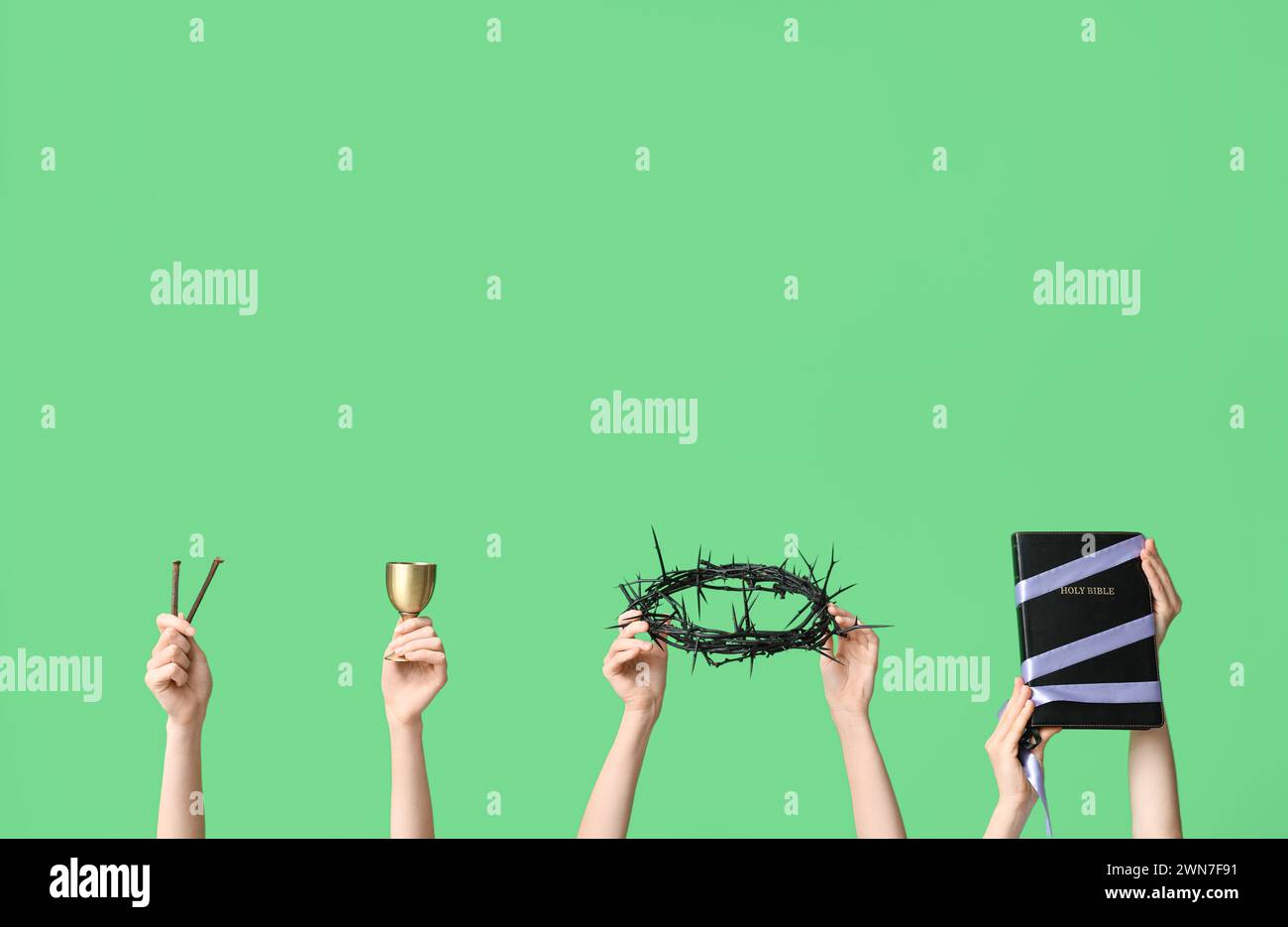 Female hands with crown of thorns, Holy Bible, cup and nails on green ...