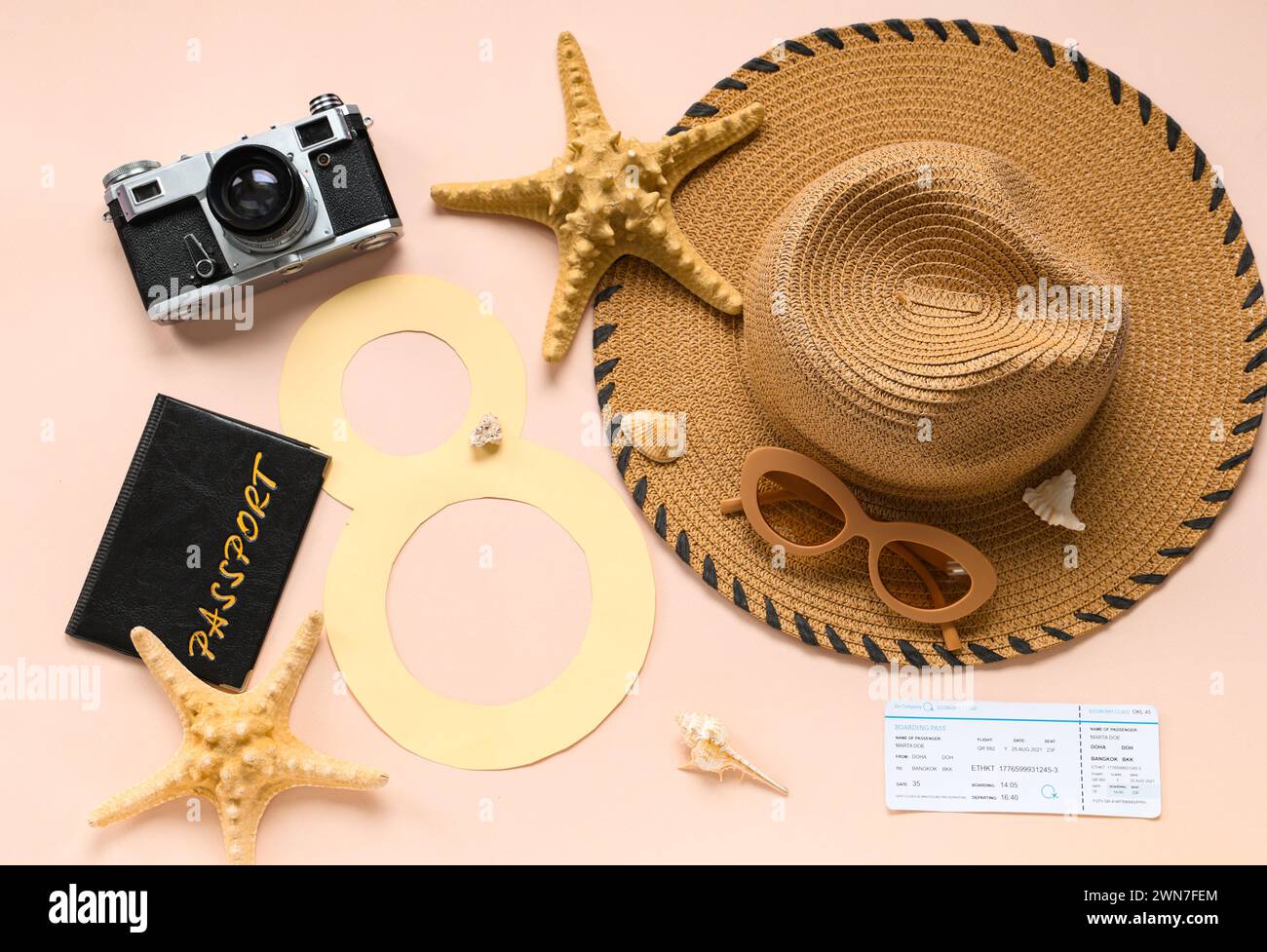 Composition with paper figure 8, beach accessories, photo camera and ...