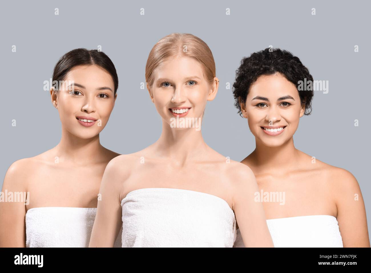 Beautiful young women on grey background Stock Photo - Alamy