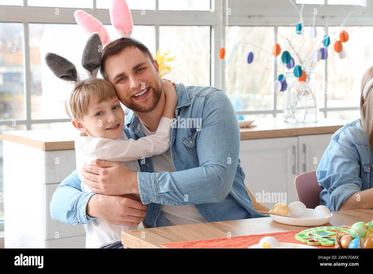 Cute little boy hugging his father at home on Easter Day Stock Photo ...